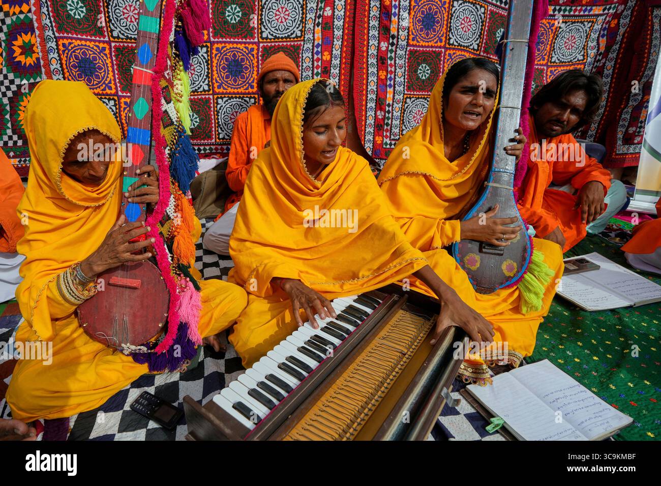 Pakistani folk musician Sham Bhai, second from right, performs with her ...