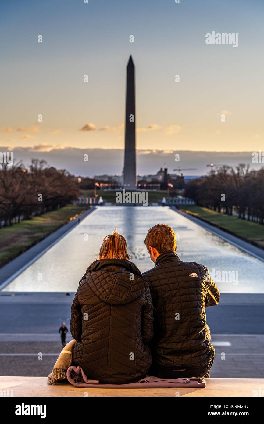 A couple gazes at the Washington Monument, a marble obelisk erected ...