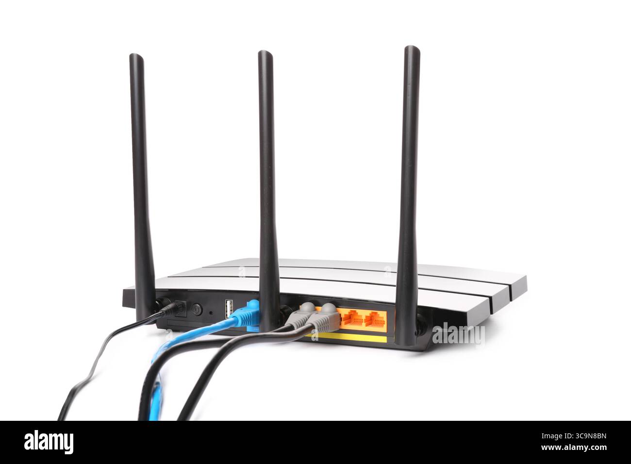 Modern wi-fi router with cables on white background Stock Photo - Alamy