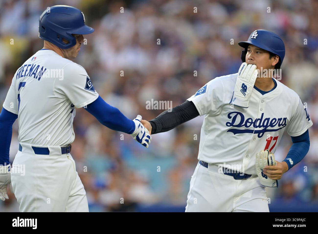 Los Angeles Dodgers' Shohei Ohtani, right, shakes hands with Dodgers ...