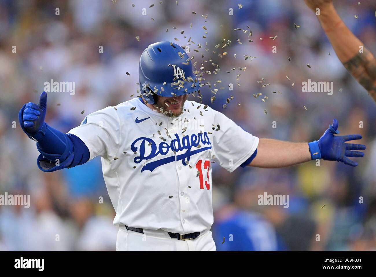 Los Angeles Dodgers' Max Muncy gets showered with seeds at the dugout ...