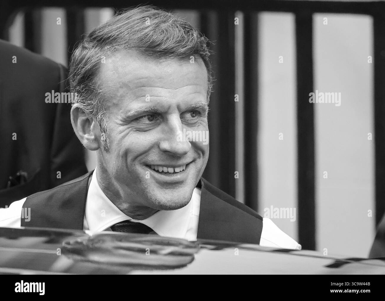 President of France Emmanuel Macron is reflected in car as he exits in ...