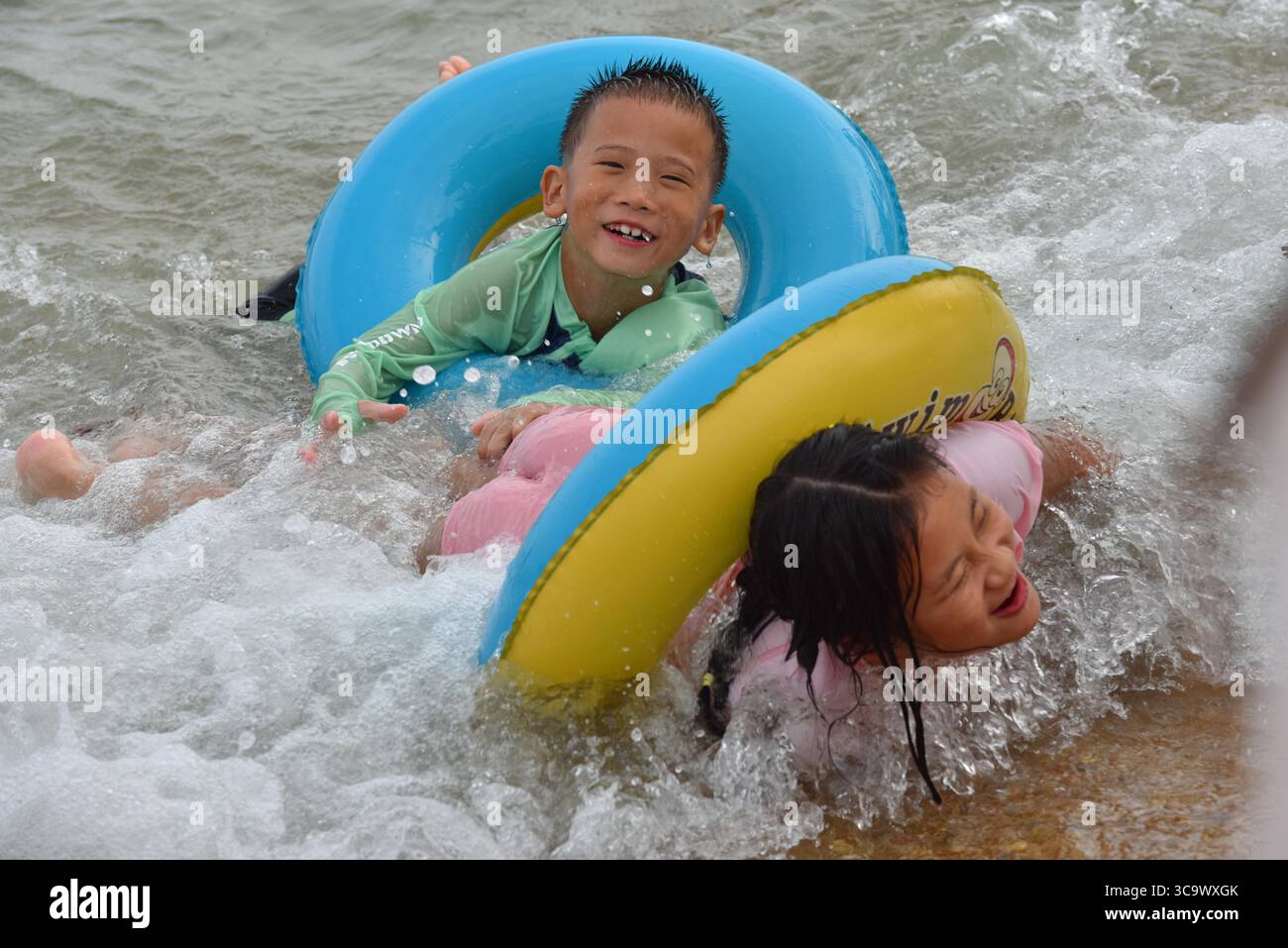 Tourists enjoy the summer time on the beach of Fujiazhuang Park in ...