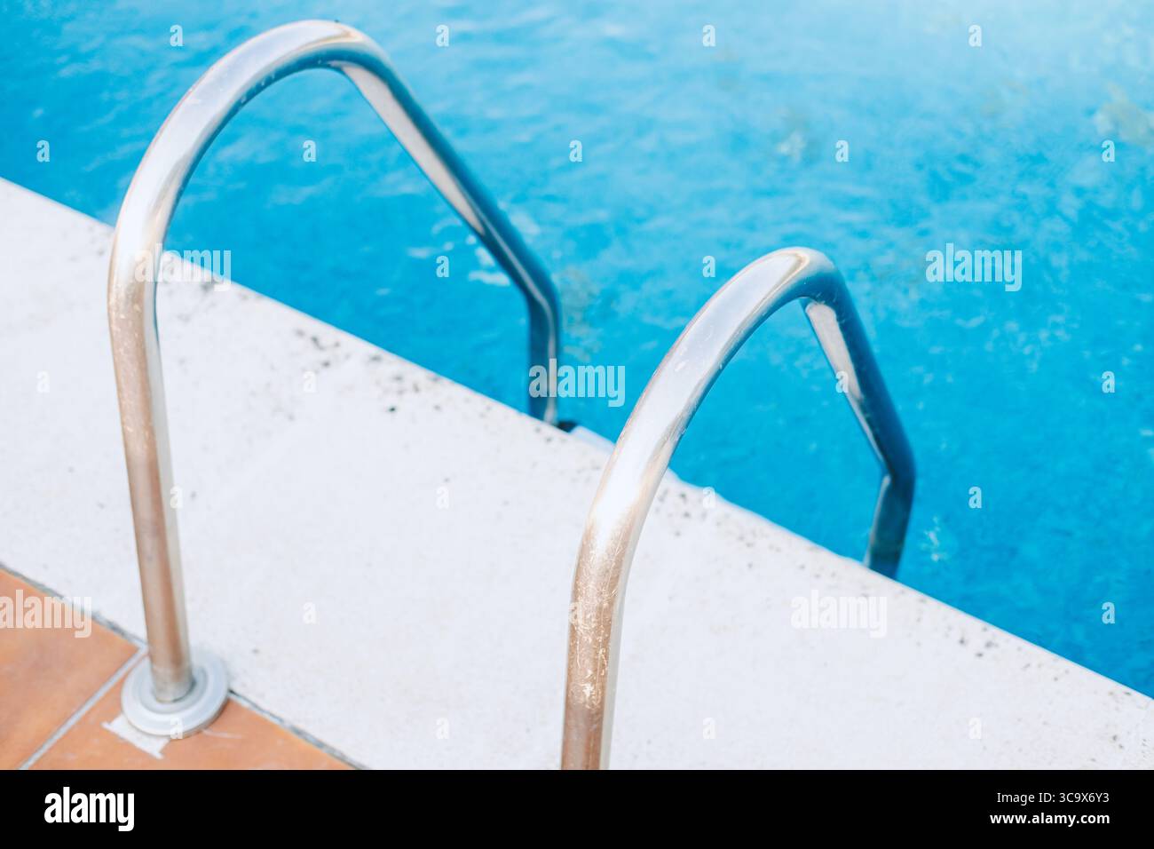 A Close up of a Poolside with a Chrome Ladder. Concept The details of a ...
