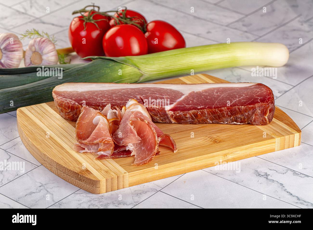 Dry parma pork meat piece with slices Stock Photo - Alamy