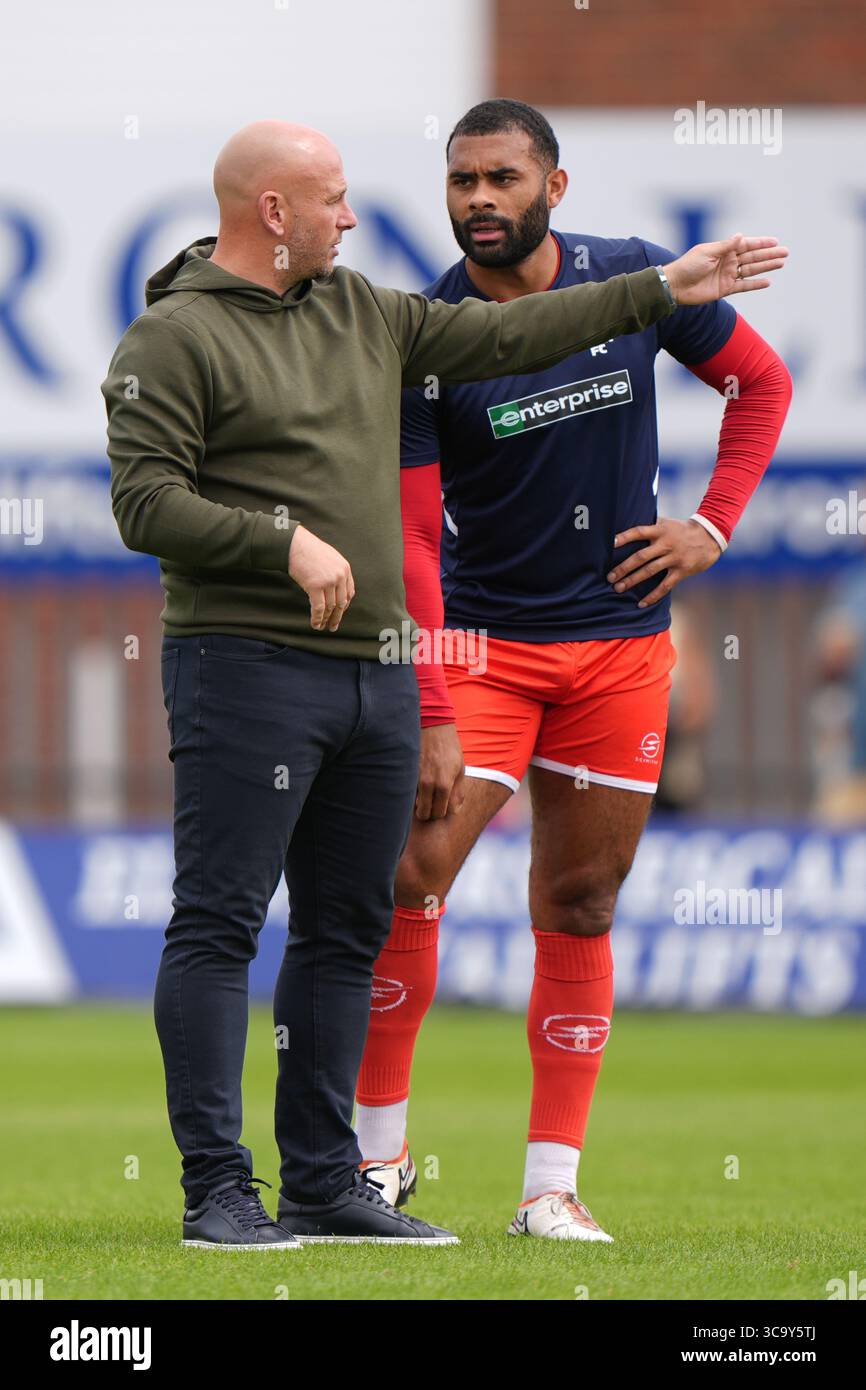 Kidderminster Harriers manager Adam Murray (left) talks to Alex Penny ...