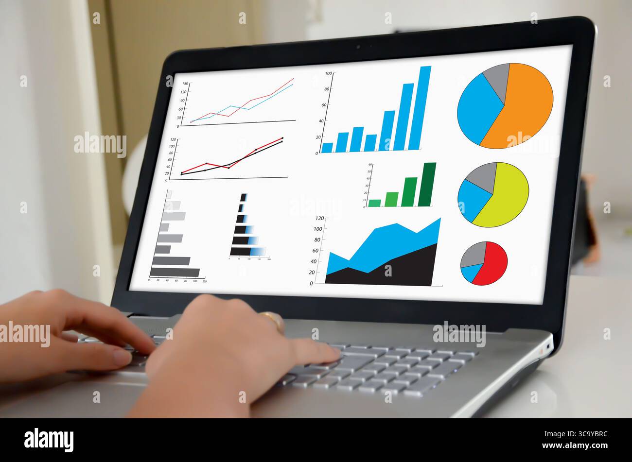 Hands on a laptop with screen showing graphical analysis concept Stock ...