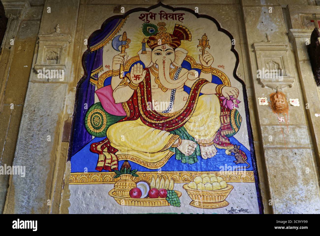 A large mural of Ganesha in bright colours, typical Hindu iconography ...