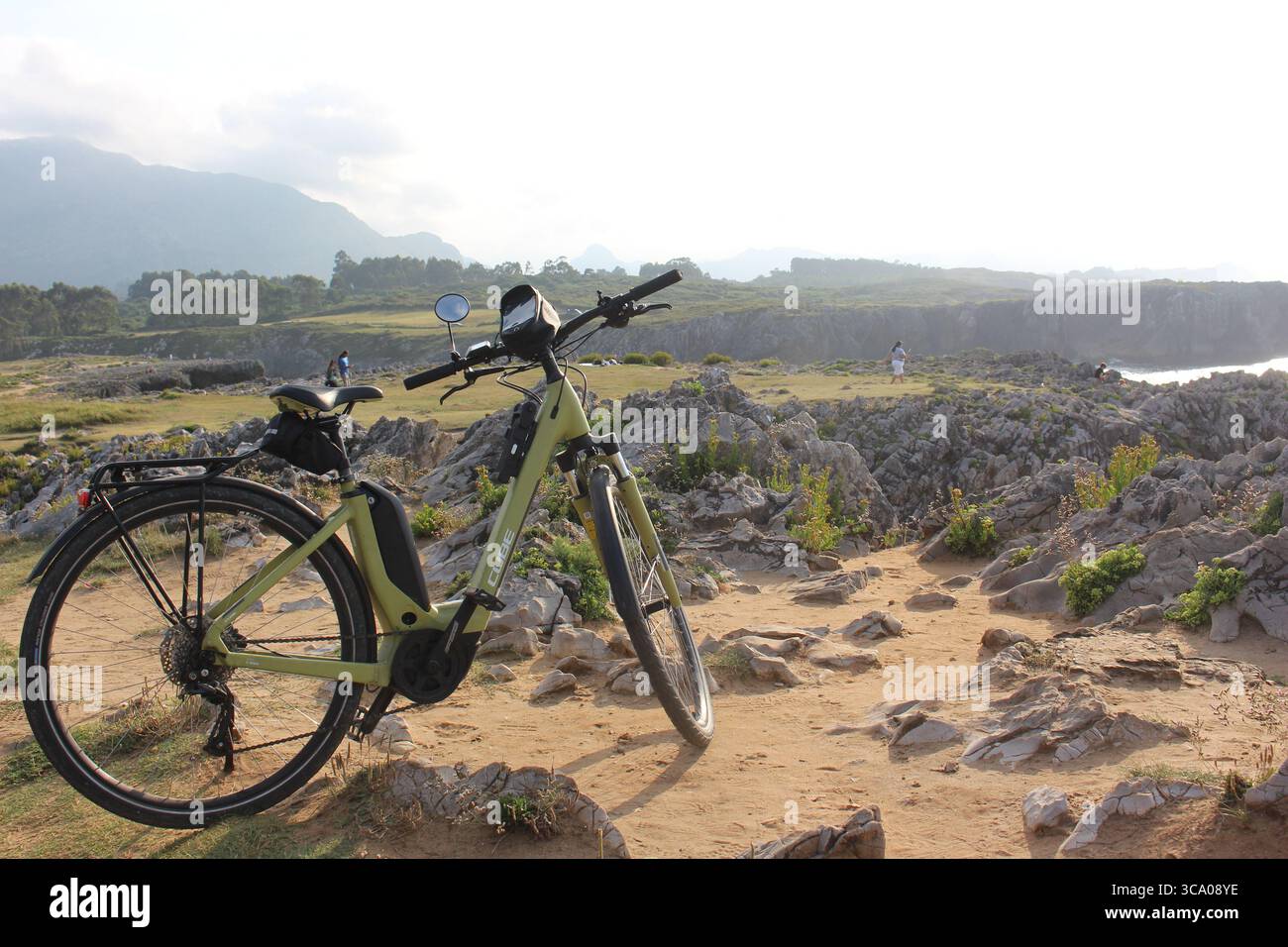 E-bike on the Camino de Santiago near Bufones de Pría, Asturias, with coastal cliffs, heathland ...