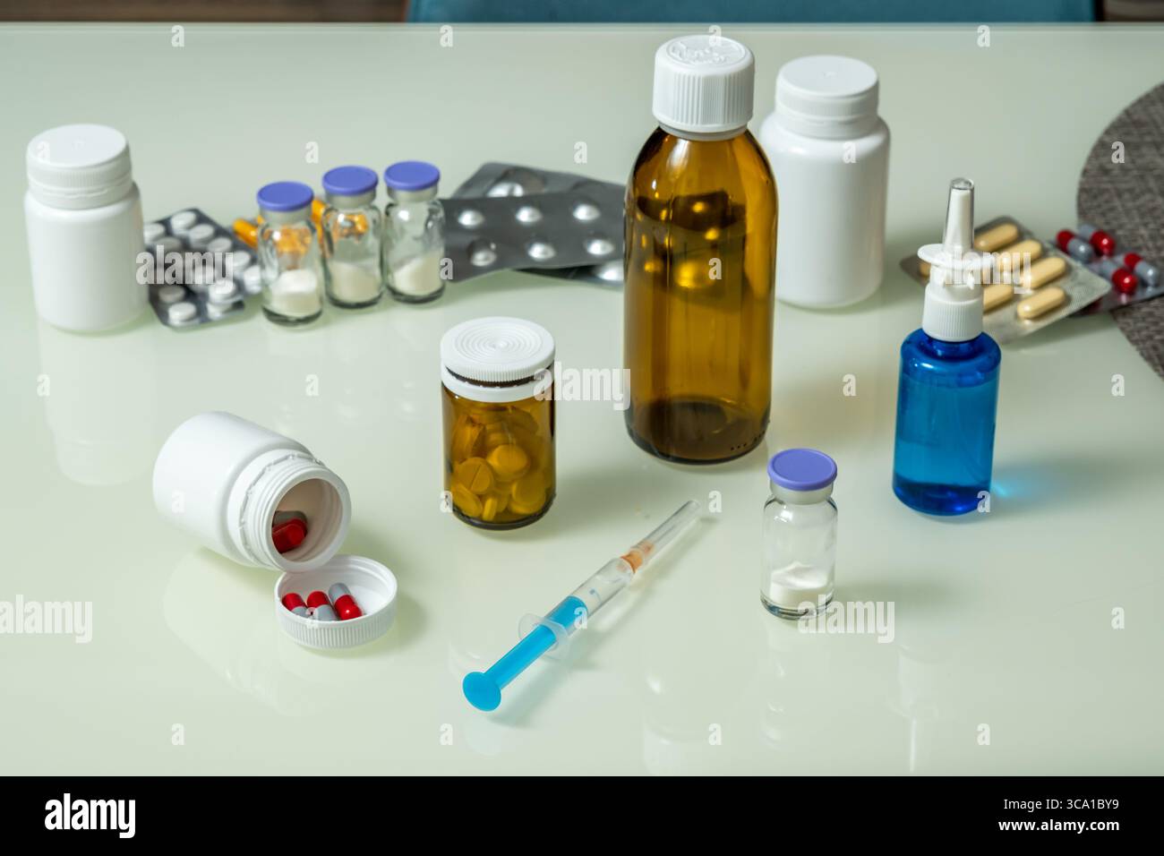 Different types of drugs or medicine on a white glass table Stock Photo ...