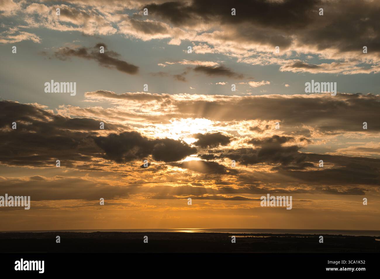 Golden sun breaking through dark hi-res stock photography and images ...