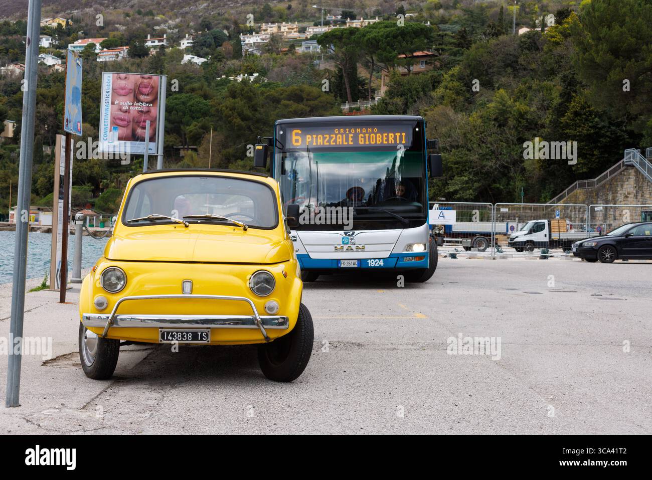 Trieste, Italy - March 30, 2025: Vintage Fiat 500 yellow parked next to ...