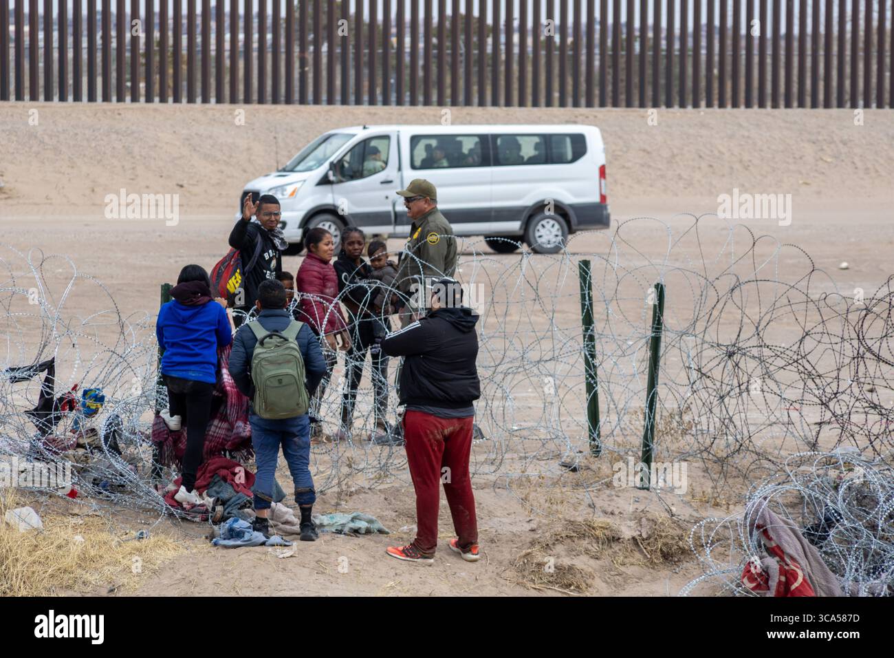 Civilians discuss with a border agent at the fortified Ciudad Juarez ...