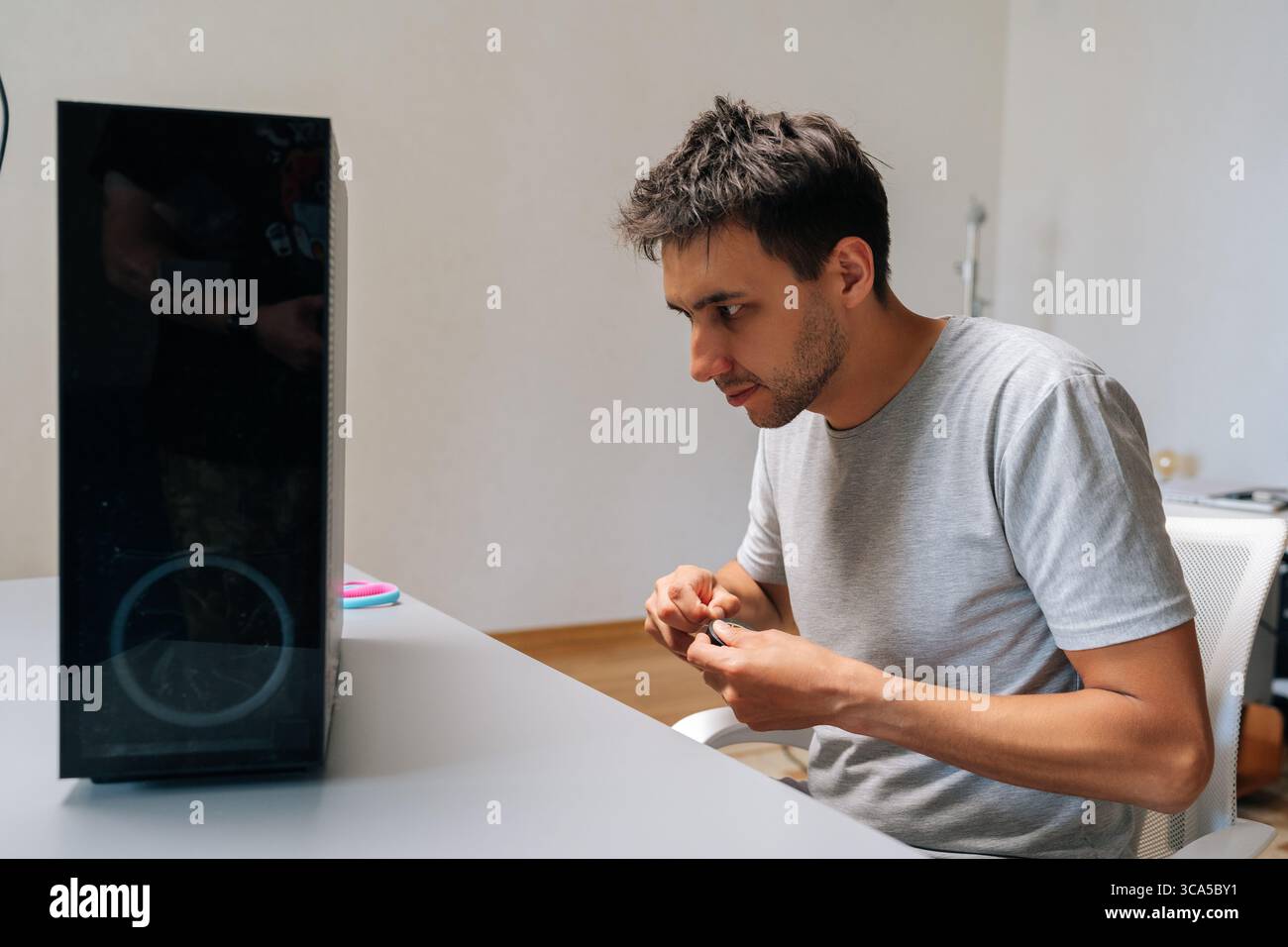 Puzzled technician male applying black electrical tape while performing ...