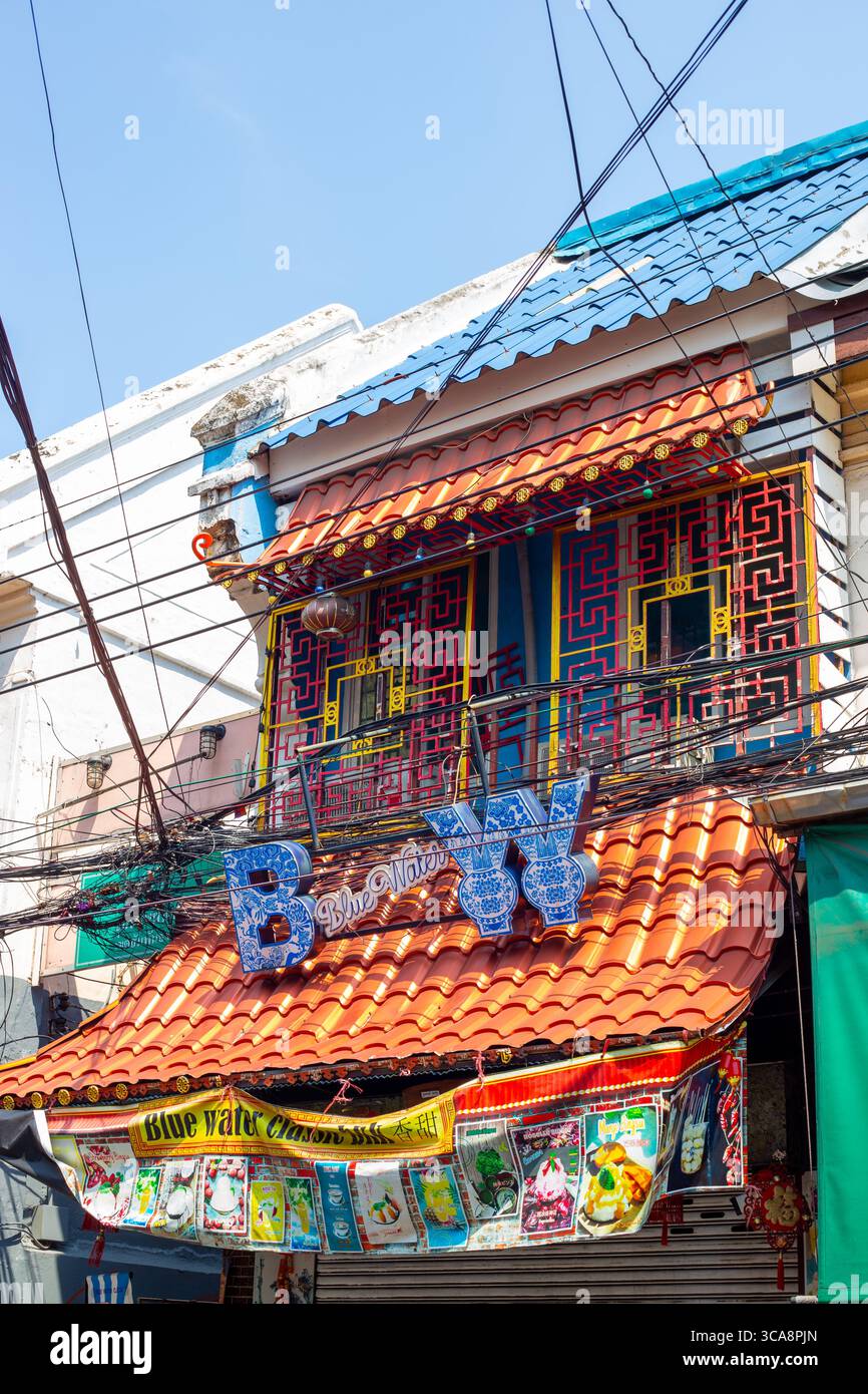 Colorful facade of Blue Water restaurant with tile roof and decorative ...