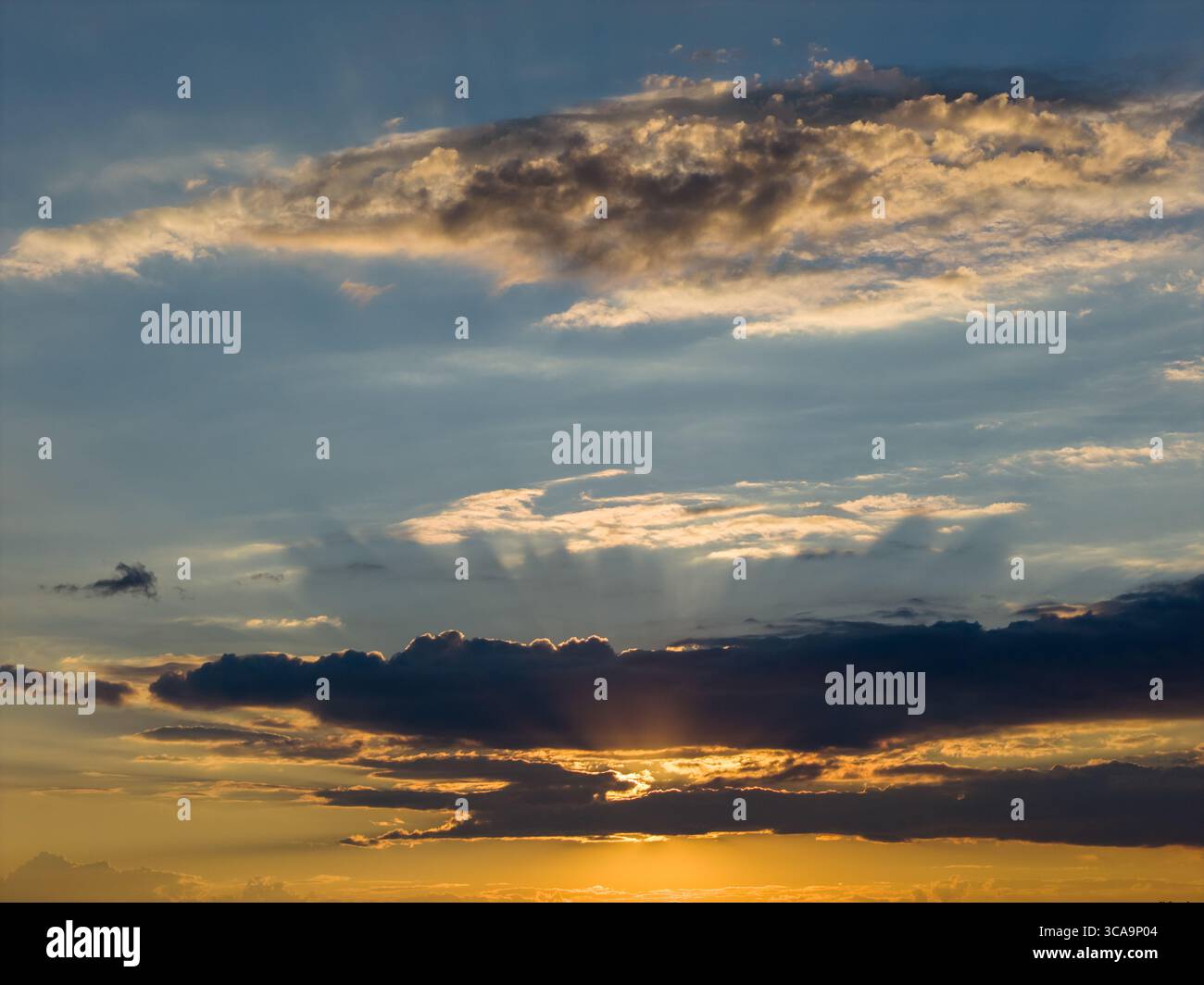 High-altitude view of layered clouds illuminated by hidden sunrays ...
