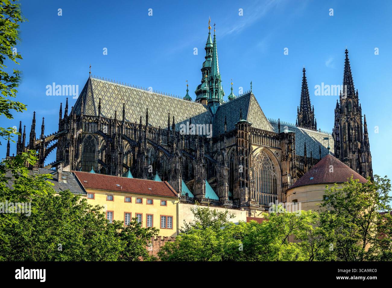 North view of St. Vitus Cathedral rising above the greenery of Prague ...