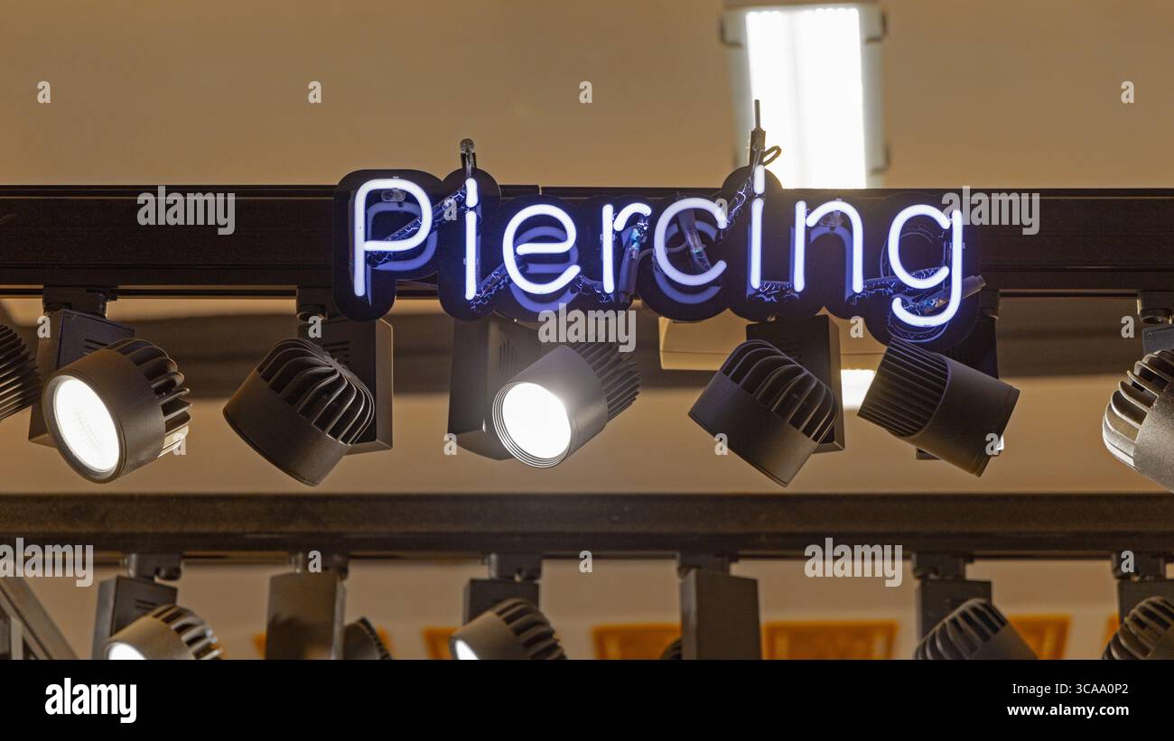 Real Neon Sign Piercing Manu Reflector Lights in Studio at Night Stock ...