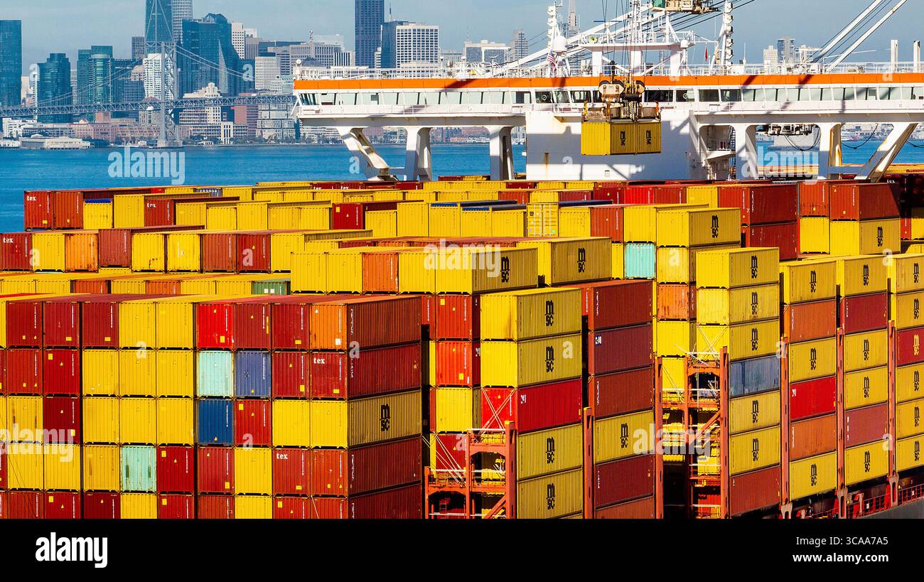 Cargo containers line a ship at the Port of Oakland on Wednesday, Aug ...