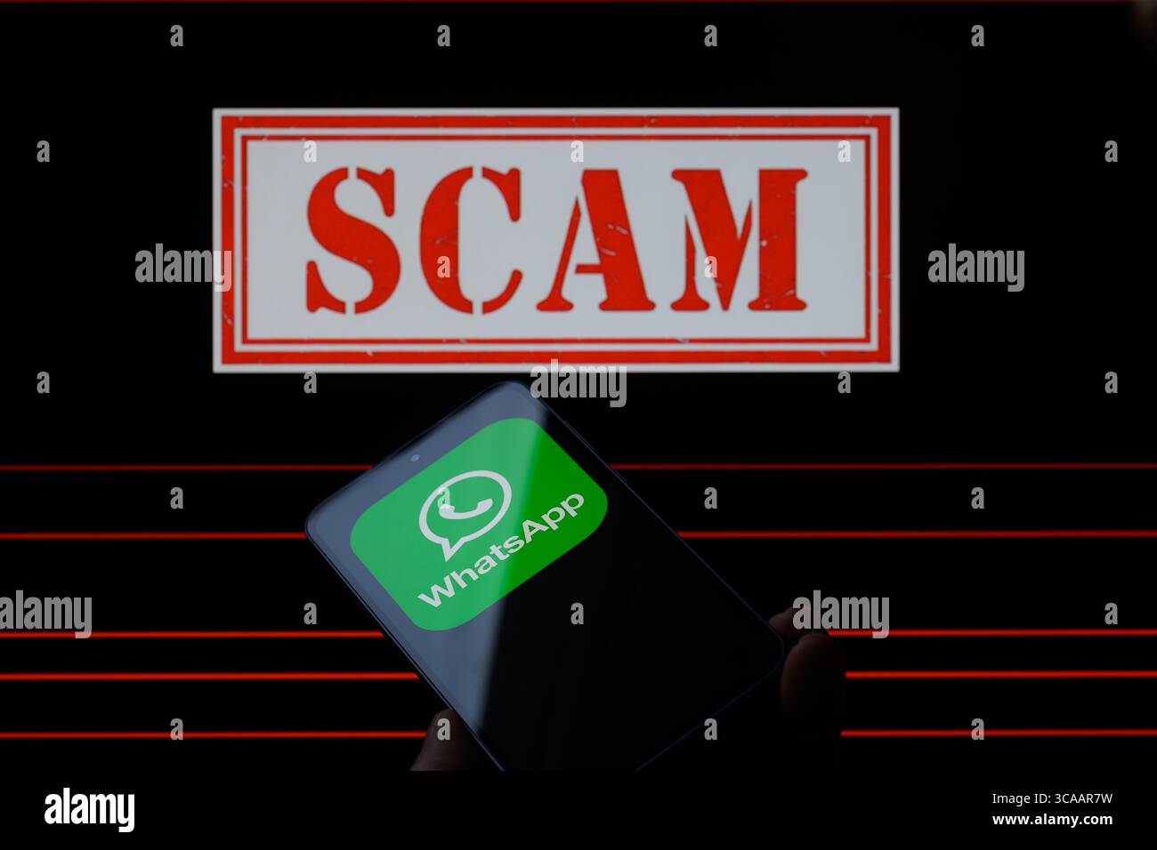 The WhatsApp logo is being displayed on a mobile phone with scam seen ...