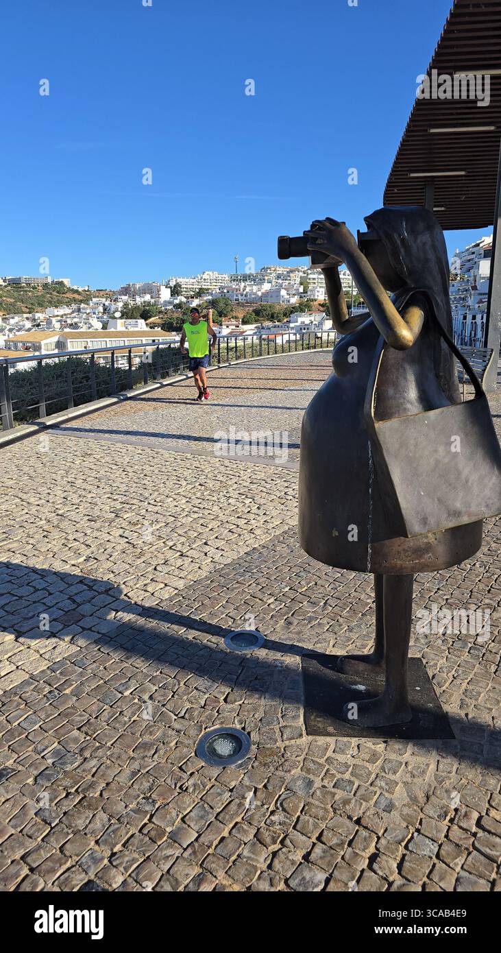 Bronze sculpture of a woman figure on the seaside promenade in ...
