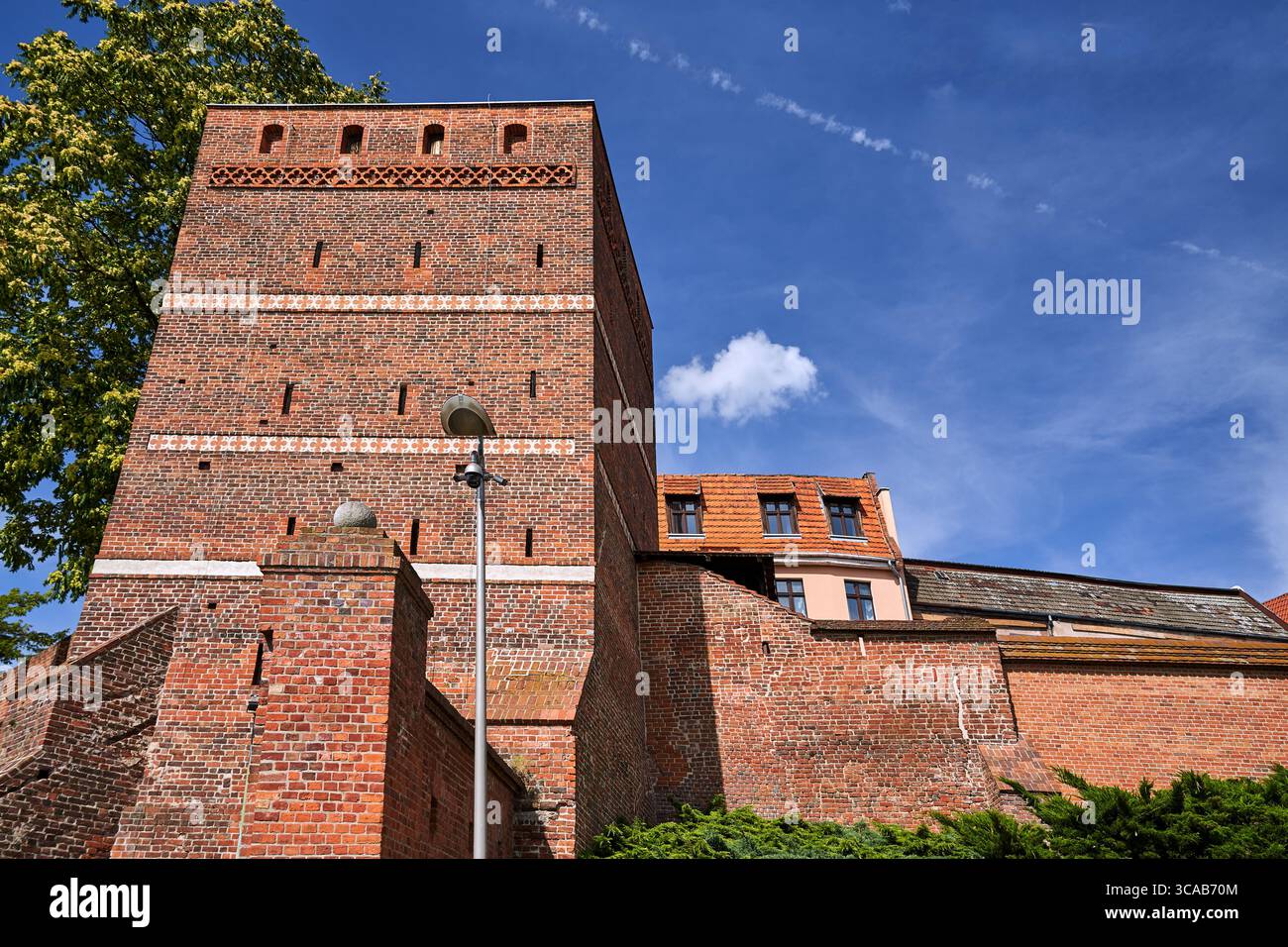 historic medieval defensive walls with a leaning tower in the city of ...