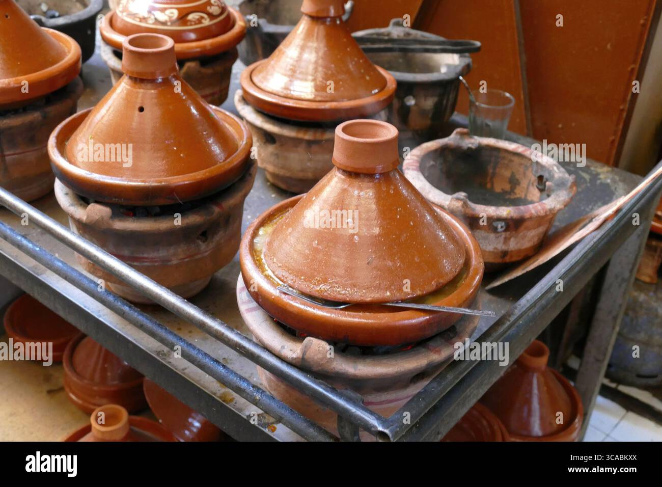 Vegetables steaming in tagine cooking pots in medina of Fes, Morocco ...