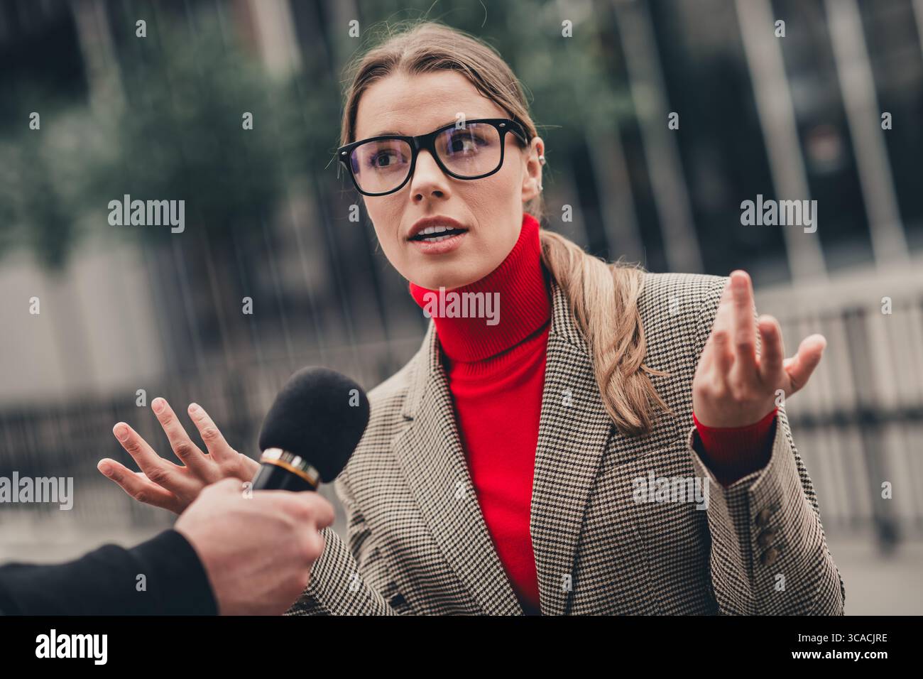 Professional lady being interviewed outdoors wearing a formal jacket ...