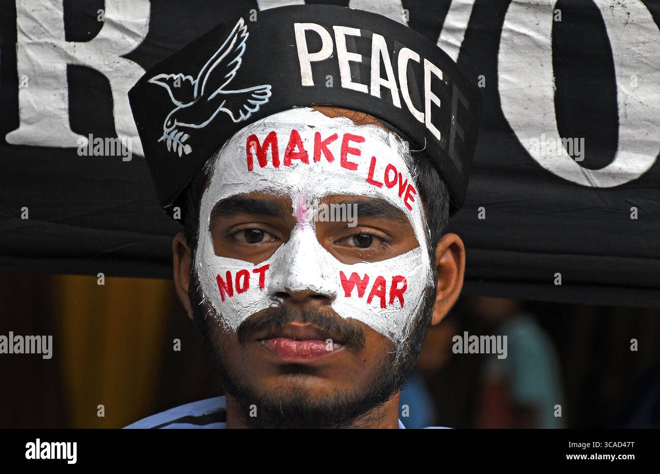 A student with his face painted 'Make Love Not War' poses for a photo ...