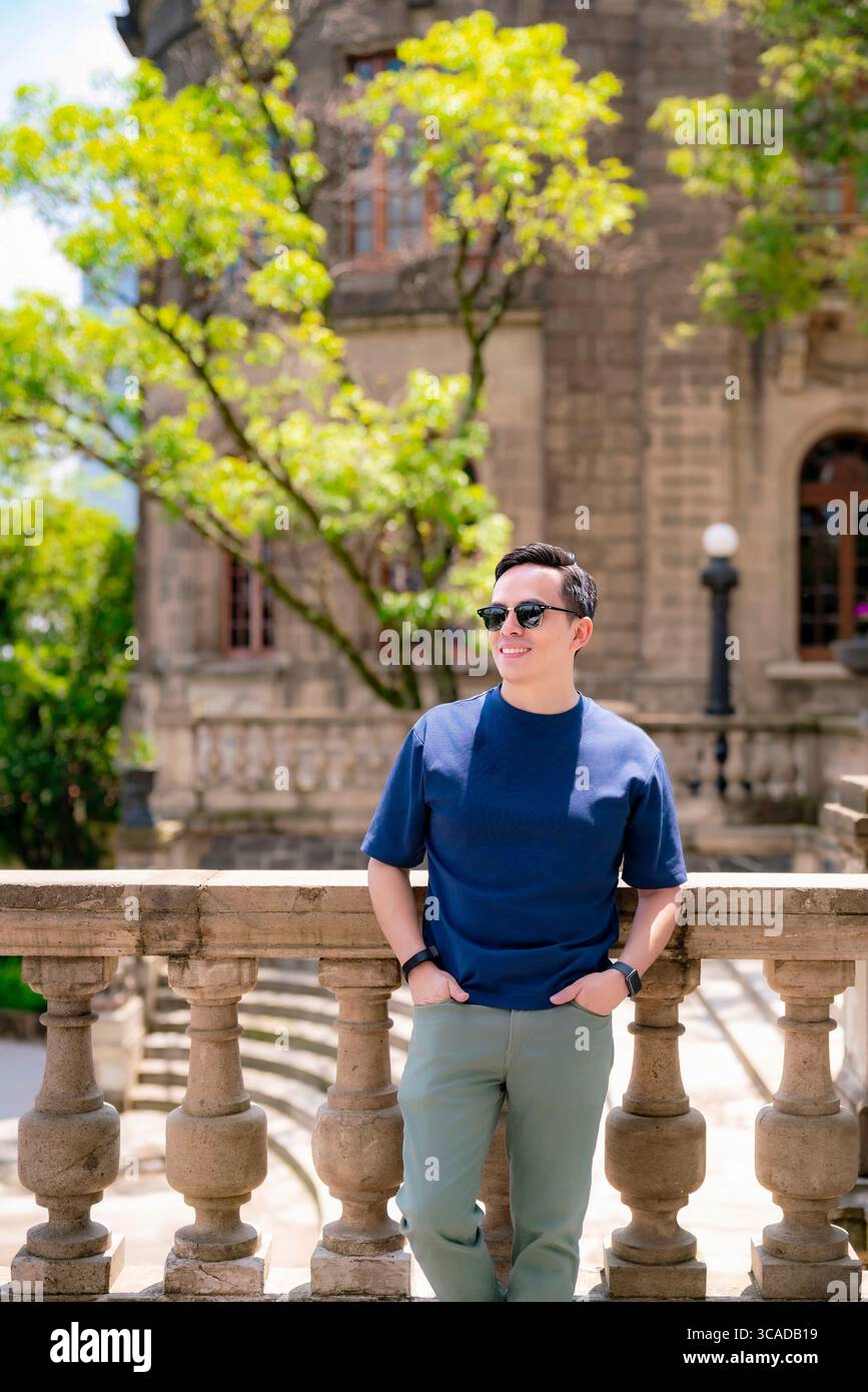 Young happy Latino man with short hair and sunglasses casually against ...