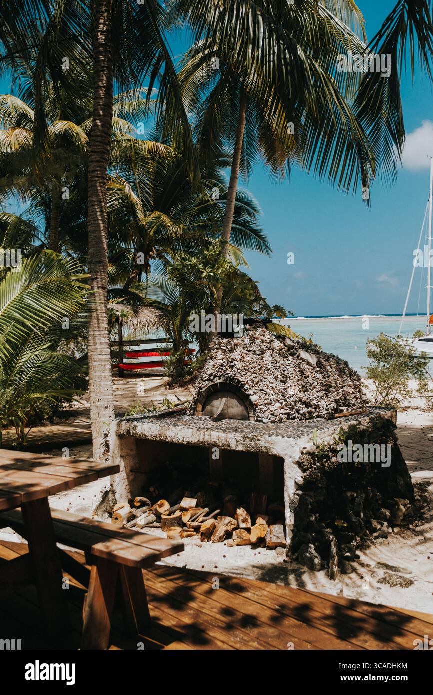 Traditional outdoor stone oven on tropical beach in Tikehau, French ...