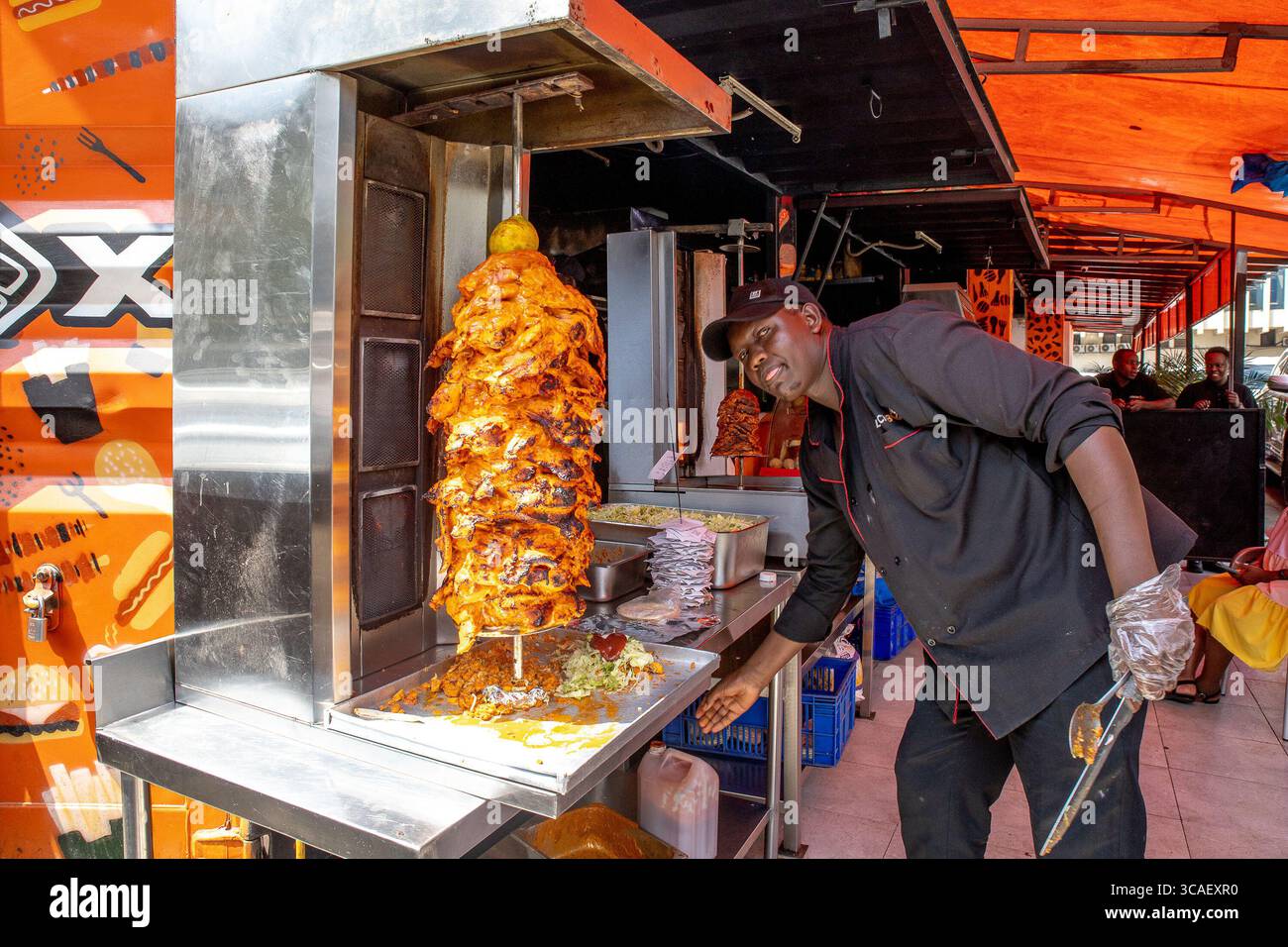 June 5, 2023, NAIROBI, KENYA: A man sells grilled chicken by the ...