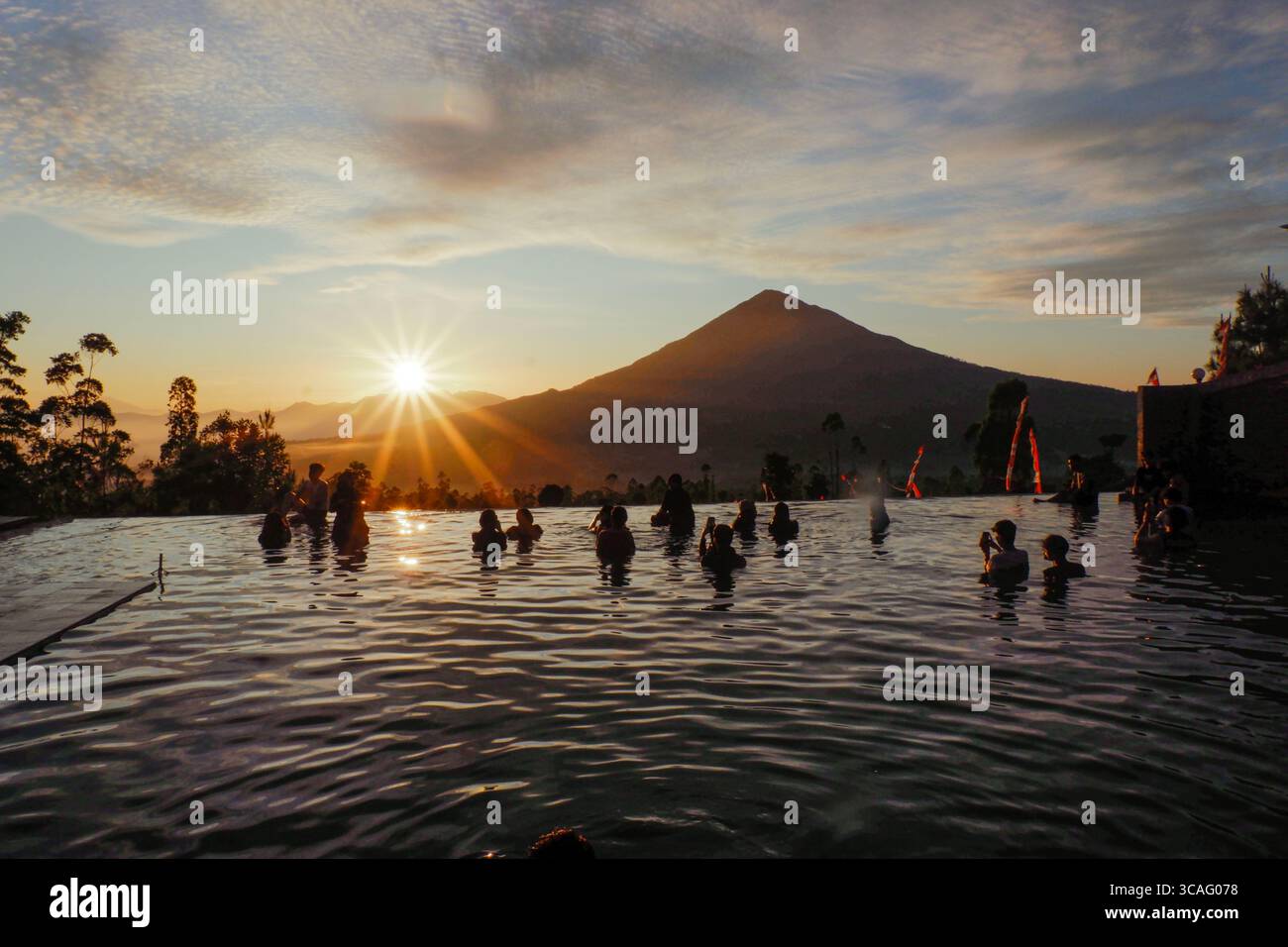 Garut, West Java, Indonesia. 7th Aug, 2025. People swim in a hot spring ...