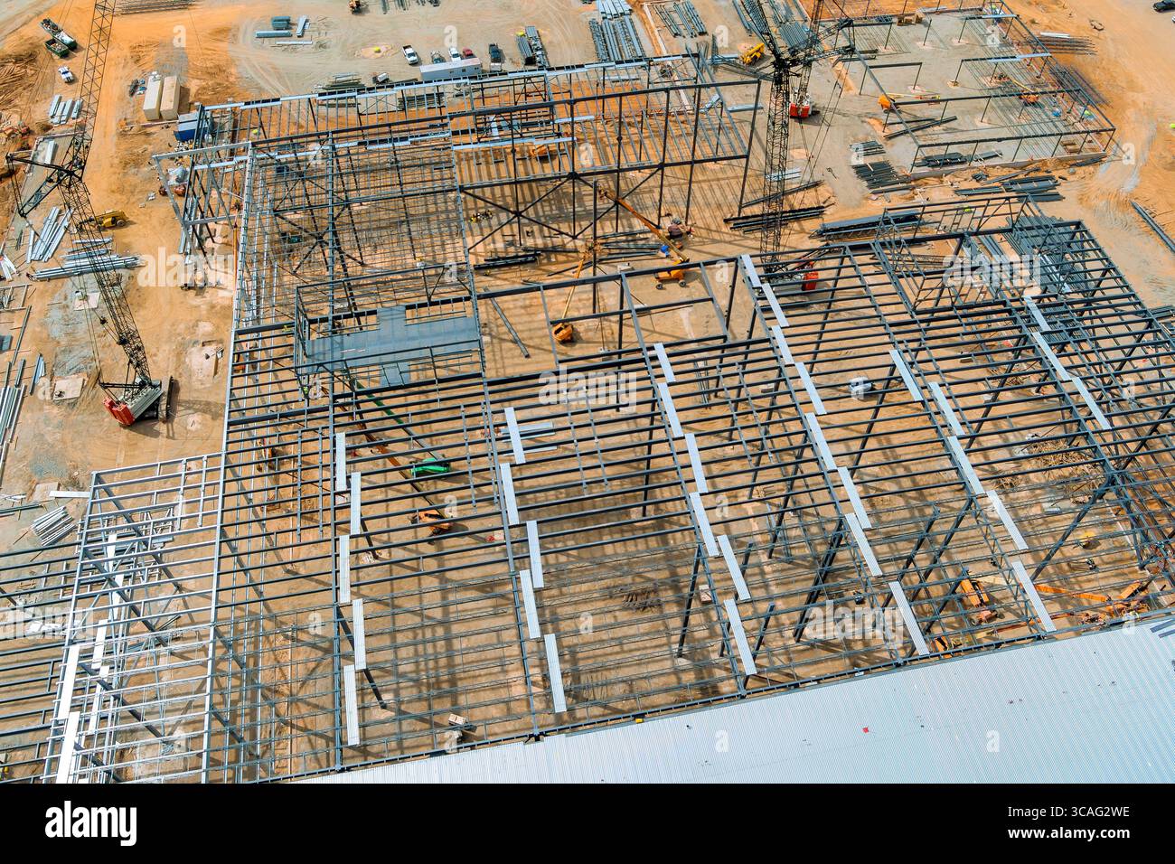 Large construction site features metal framework being erected amidst ...