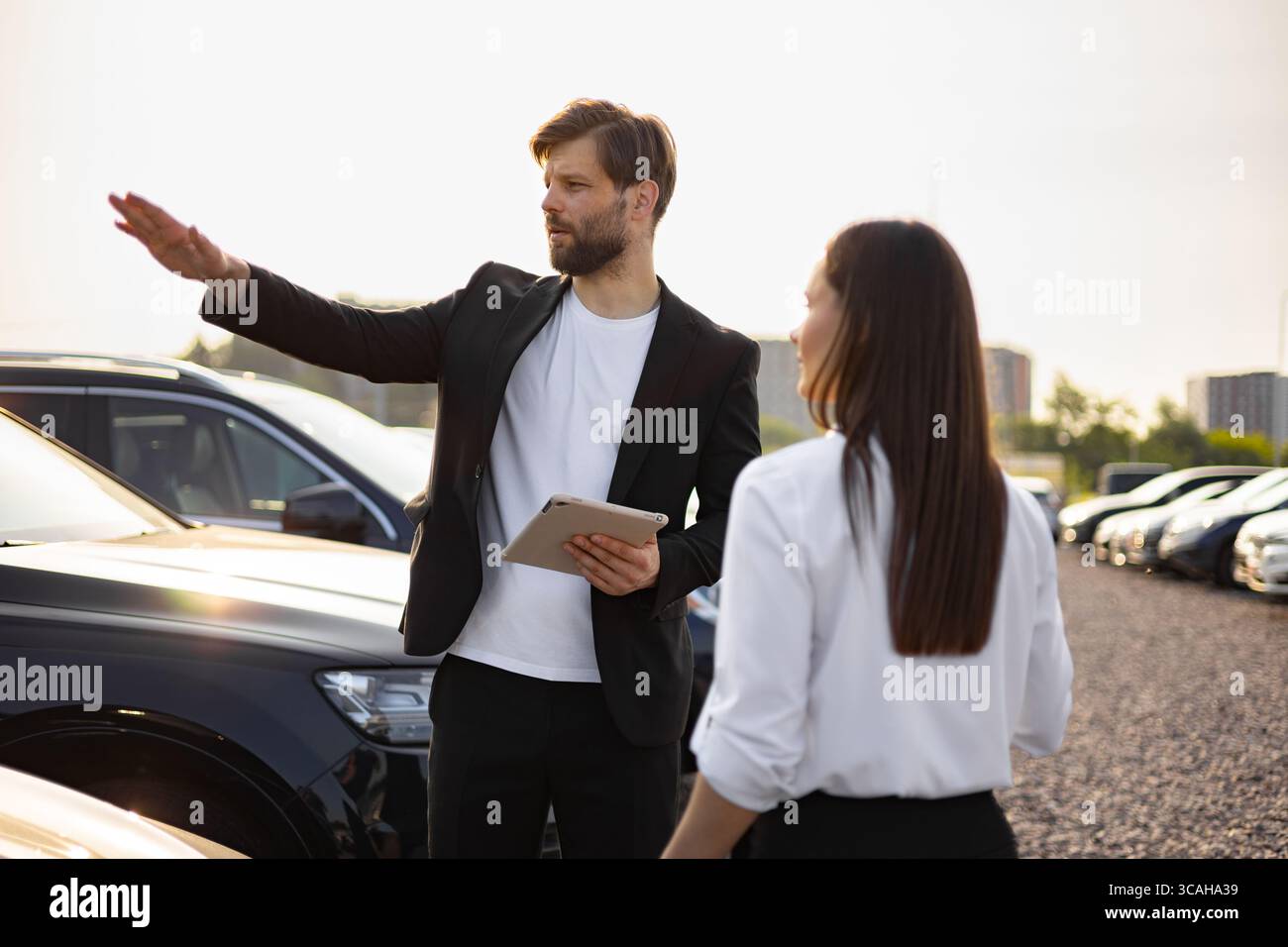 Car Dealer Explaining Vehicle to Buyer Stock Photo - Alamy