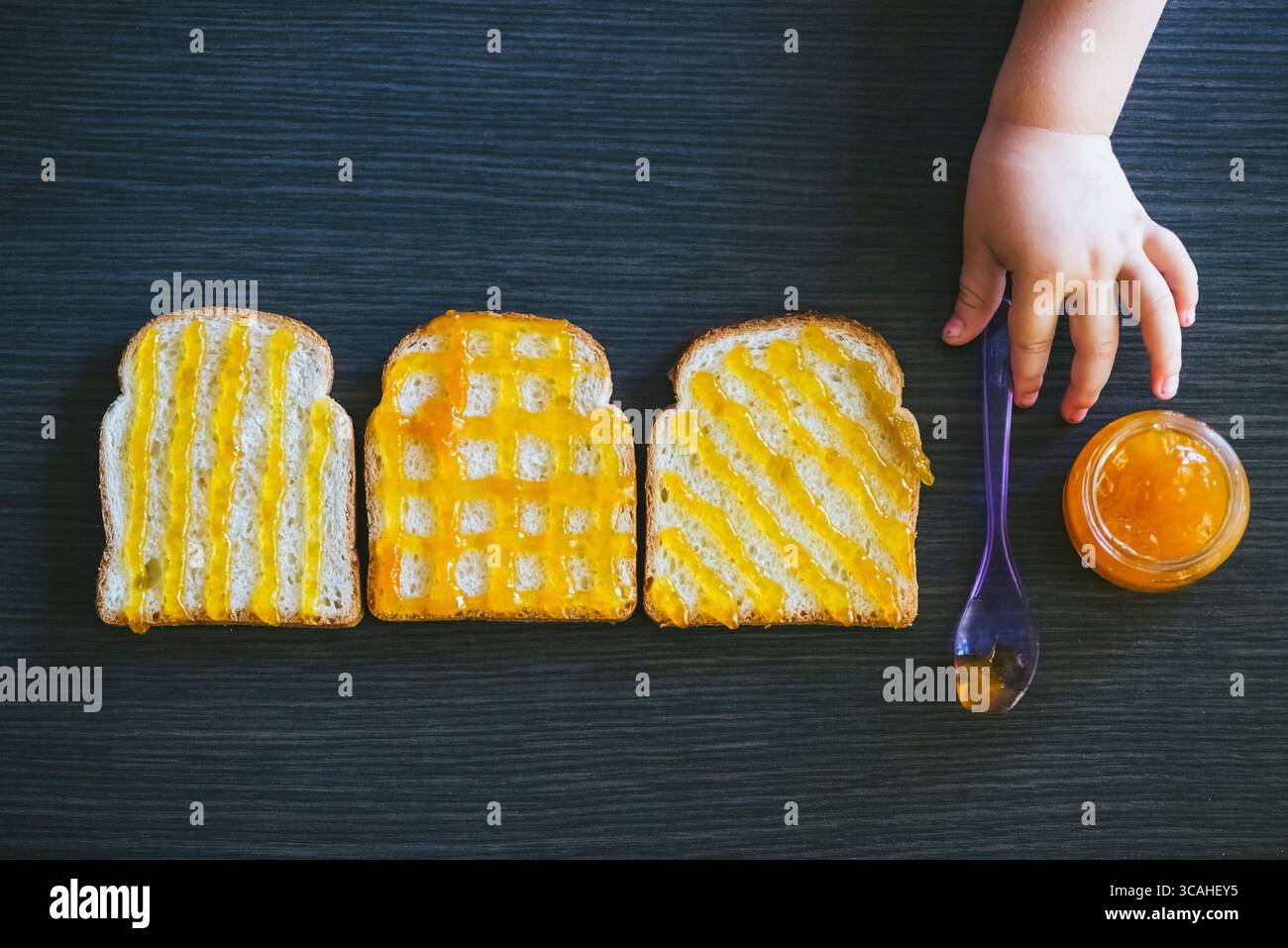 Hand holding toast spoon hi-res stock photography and images - Alamy