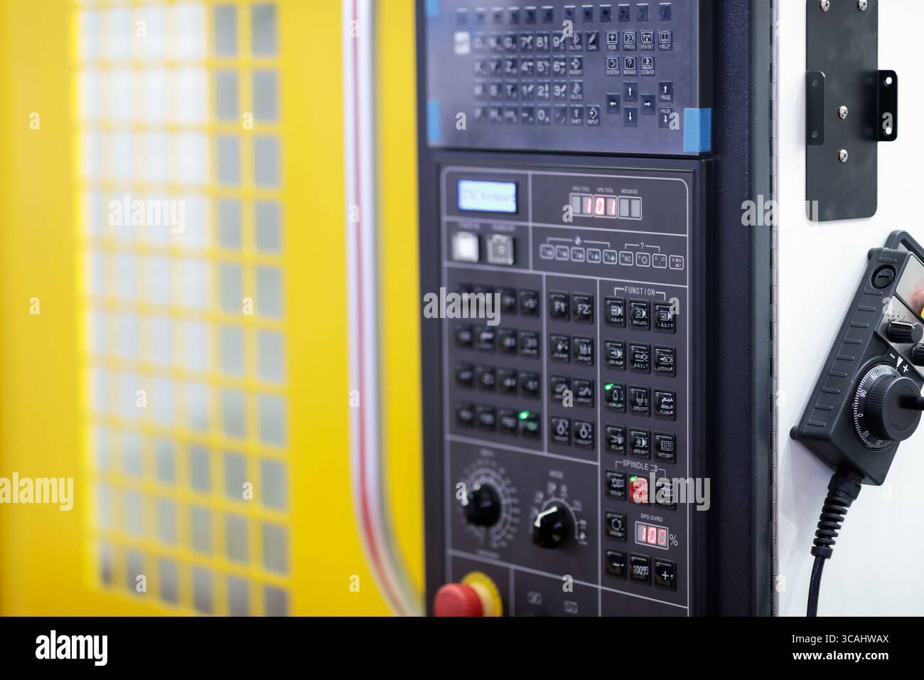 CNC machining center close up. CNC control panel and handheld remote ...