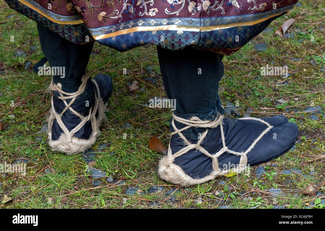 Samurai (侍) in costume wearing waraji (草鞋) woven rice straw sandals on ...