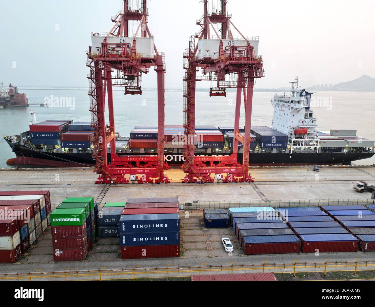 A cargo ship is loading and unloading containers at the berth of ...