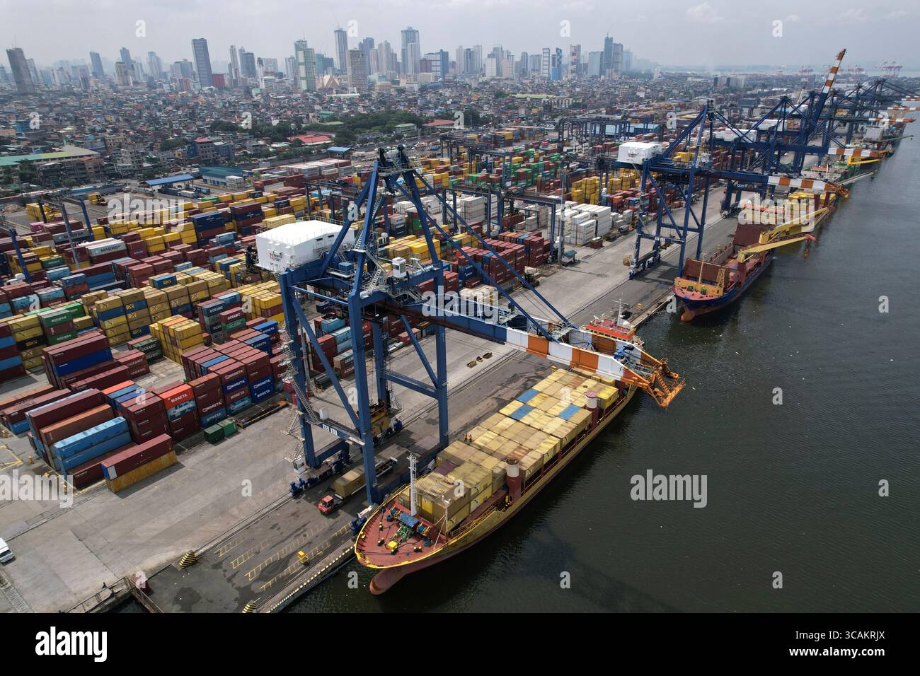 Ships are loaded with containers at the Manila North Harbour Port in ...