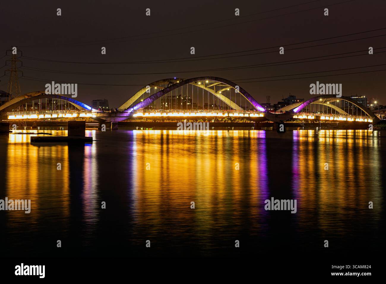 The modern Hatirjheel Bridge illuminated at night, with the glowing ...