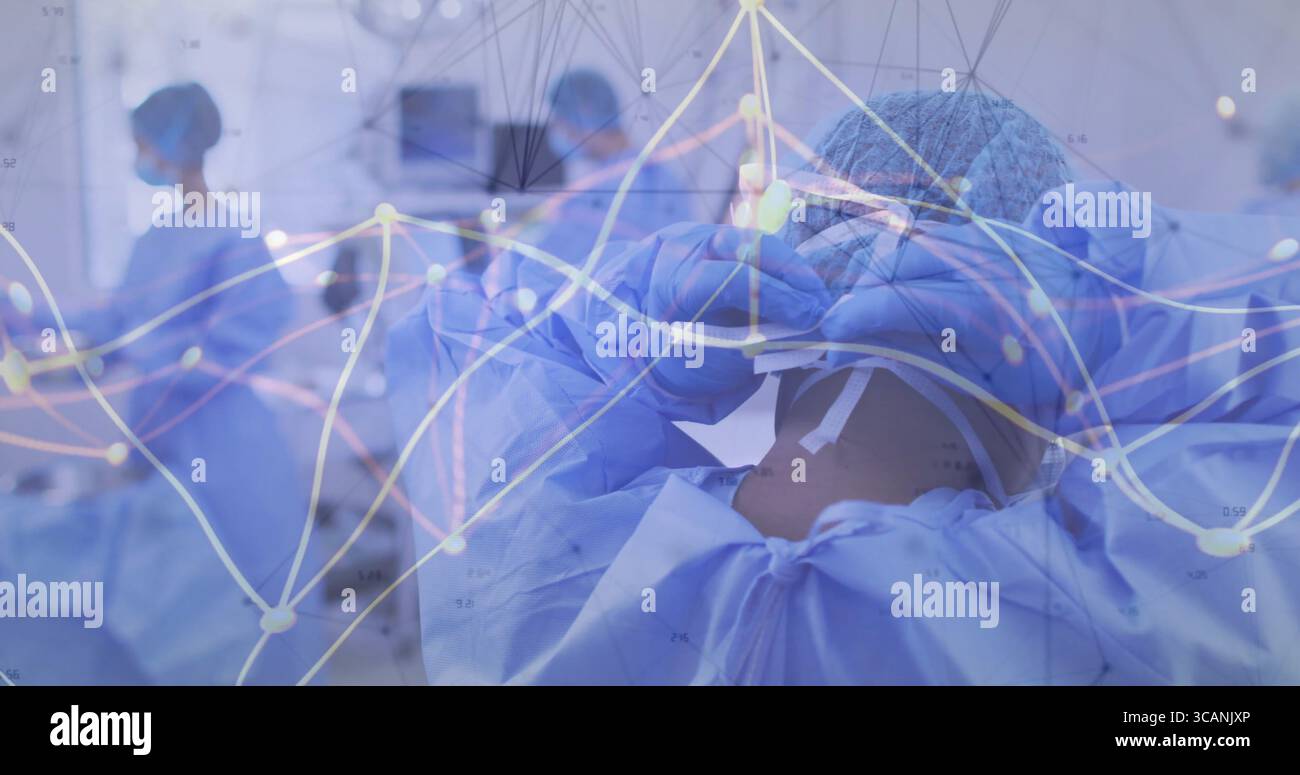 Surgical team member in blue scrubs adjusting mask and cap in operating ...