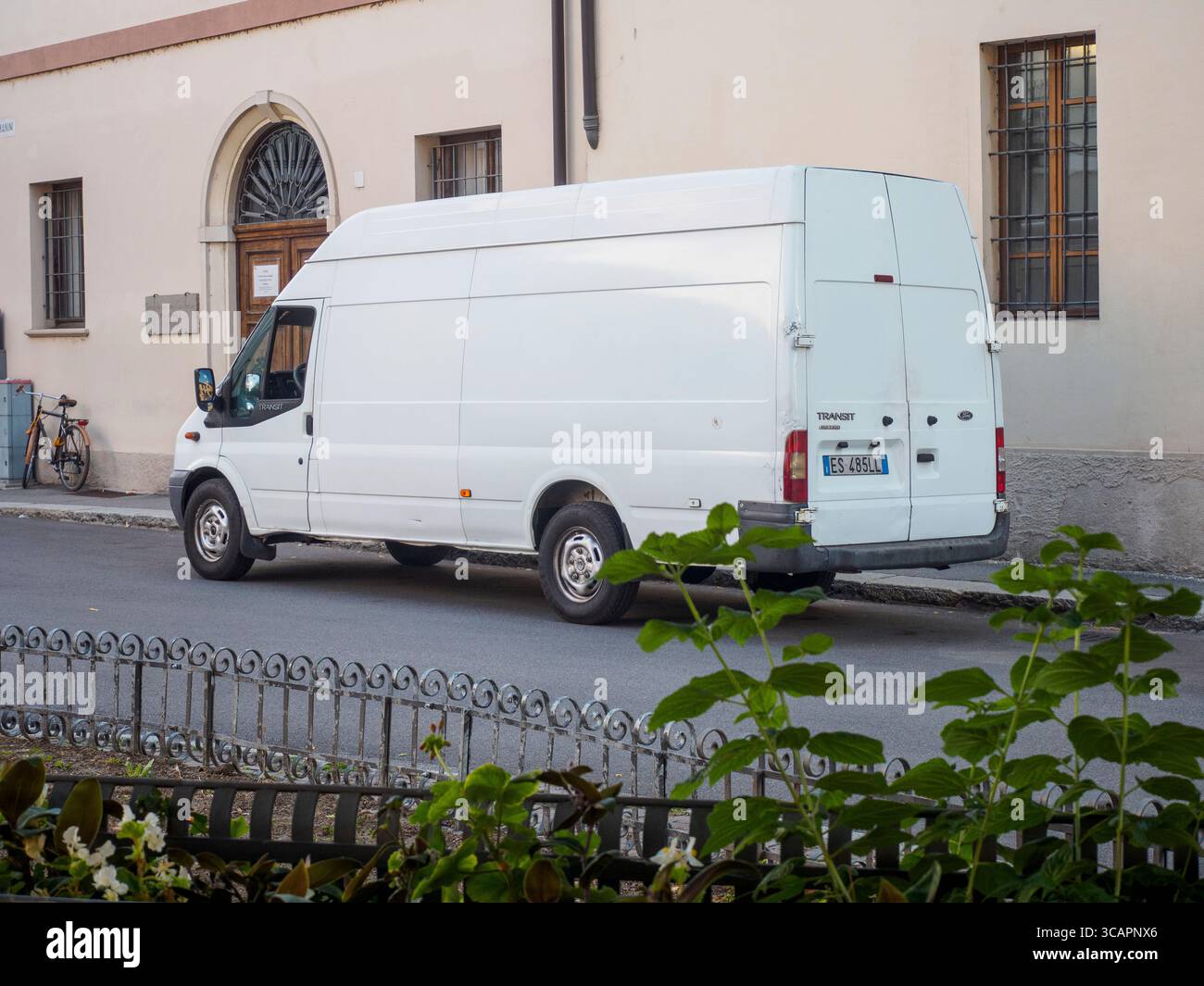 Cremona, Italy August 4th 2025 White Ford Transit van parked beside ...