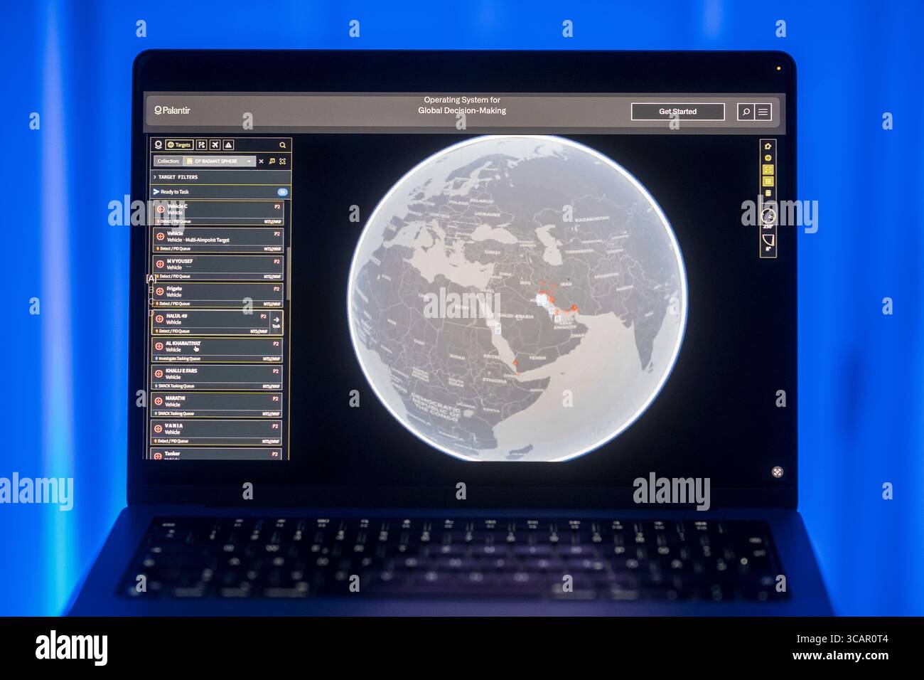 A laptop in the dark shows the user interface of the Palantir software ...