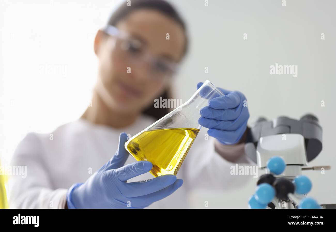 Lab technician conducts qualitative analysis of chemical compound in a ...