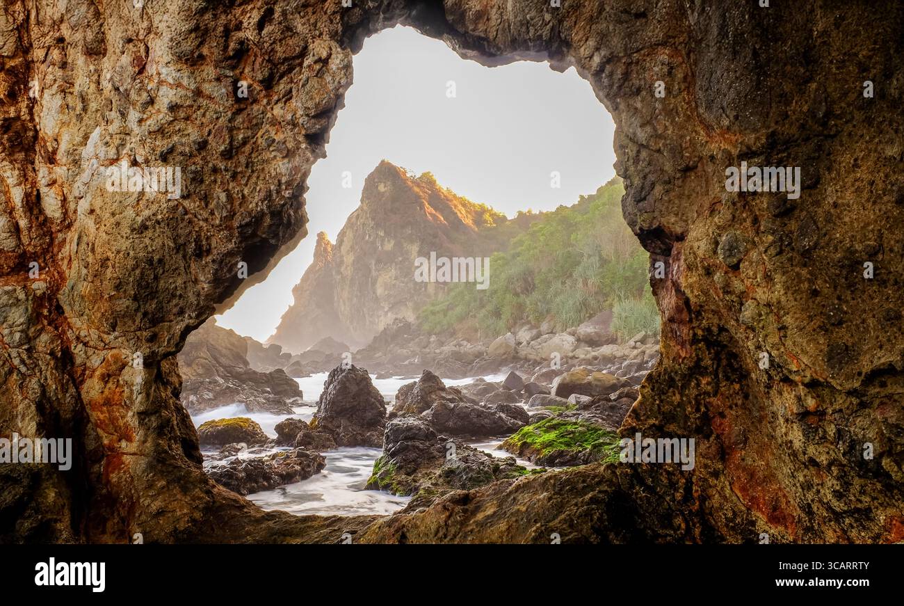 Rocky Seaside Landscape from Cave View during sunset in Yogyakarta ...