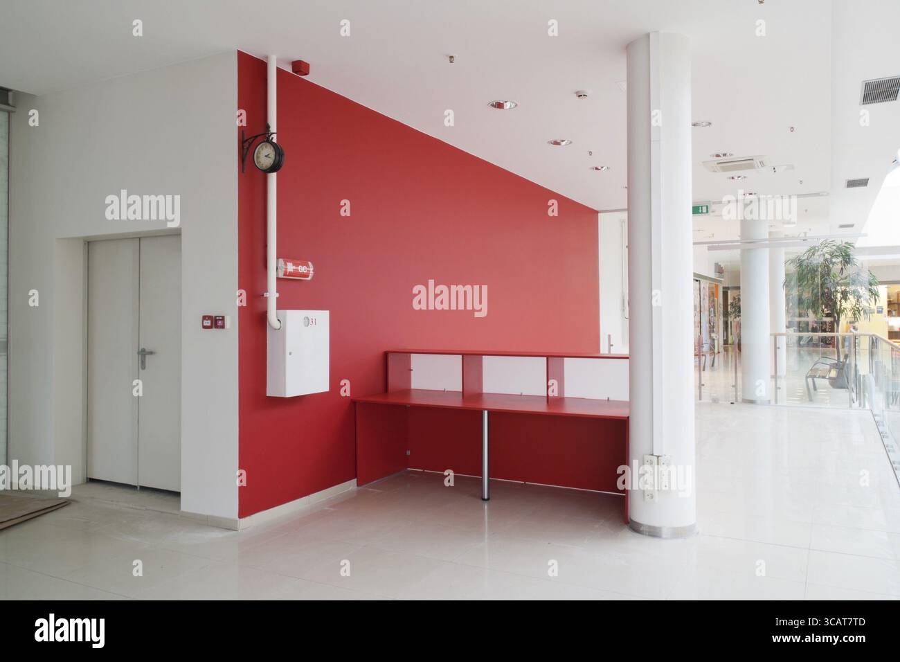 Big red wall at empty modern mass production office Stock Photo - Alamy