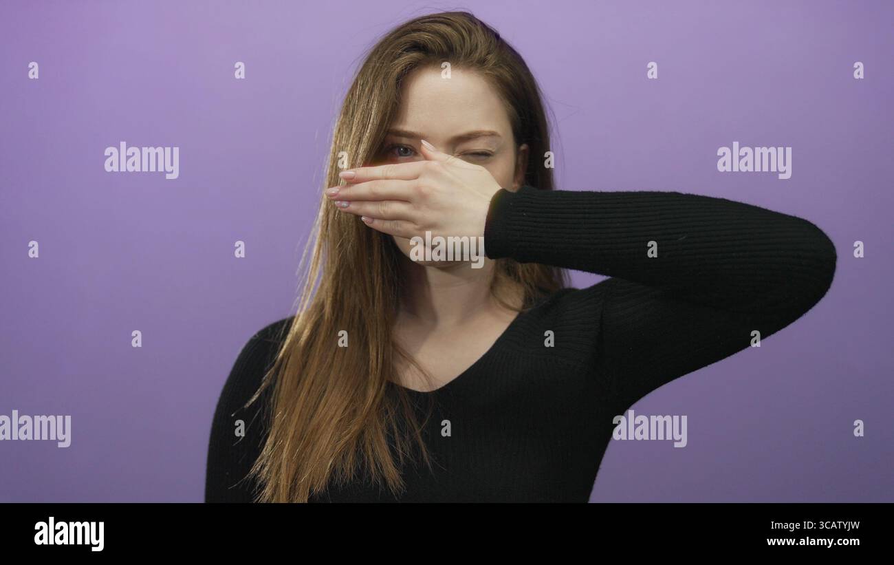 Young caucasian woman with long brown hair pinches nose and tightly ...