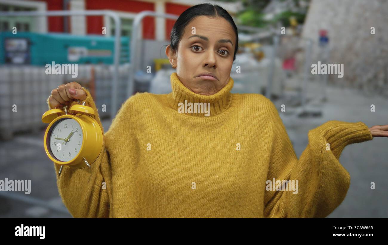 Woman shrugging yellow alarm hi-res stock photography and images - Alamy