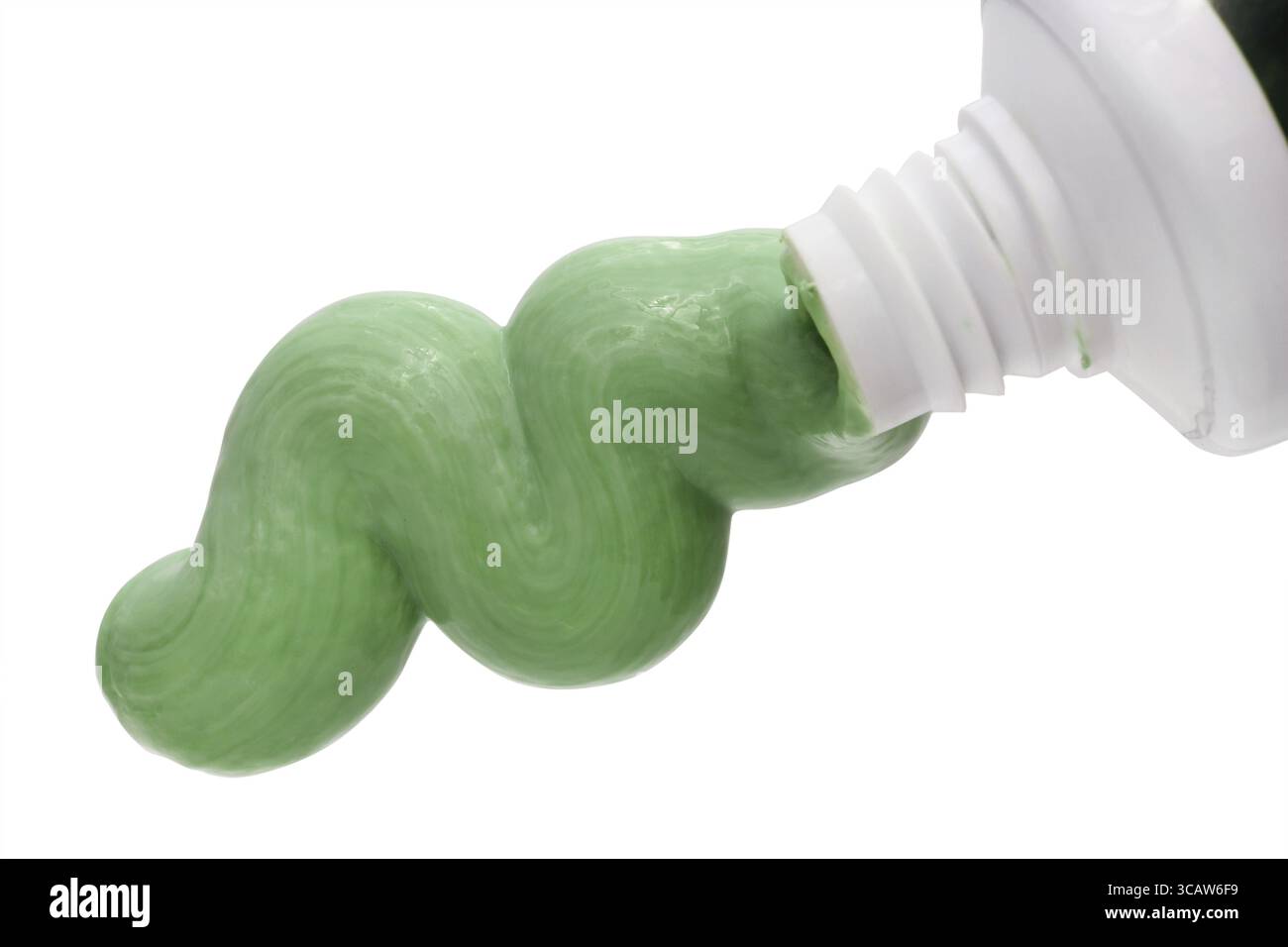 Green herbal toothpaste was squeezed out of a plastic tube. Isolated on ...